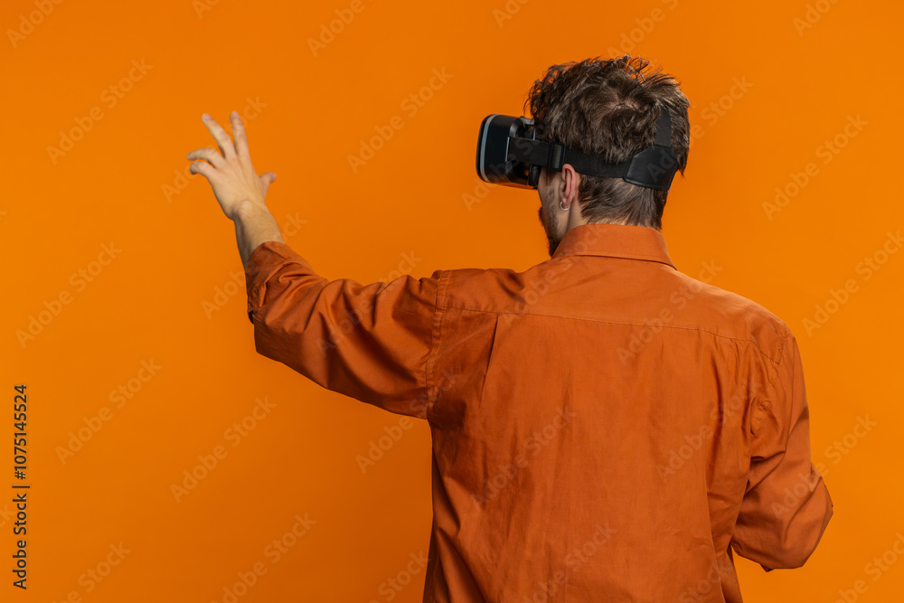 Rear back view excited happy man using headset helmet app to play ...