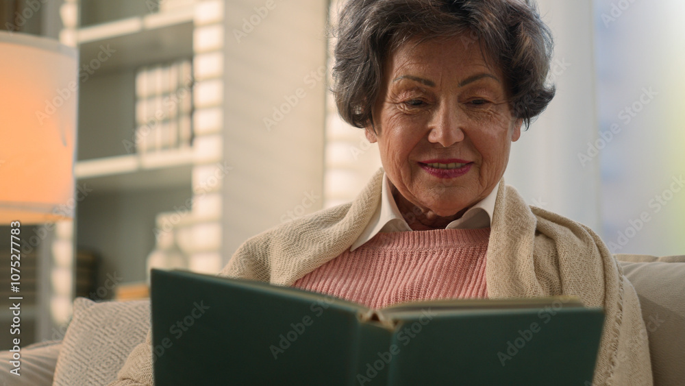 Happy inspired Caucasian old woman reading book smiling nostalgic ...