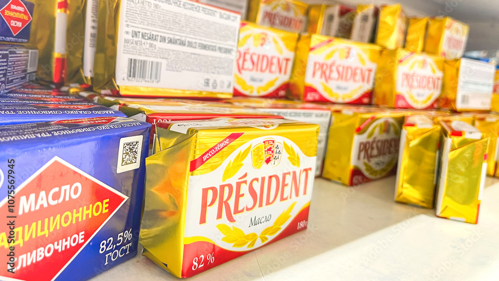 Moscow November 10 2024, A shelf full of yellow and red butter boxes ...