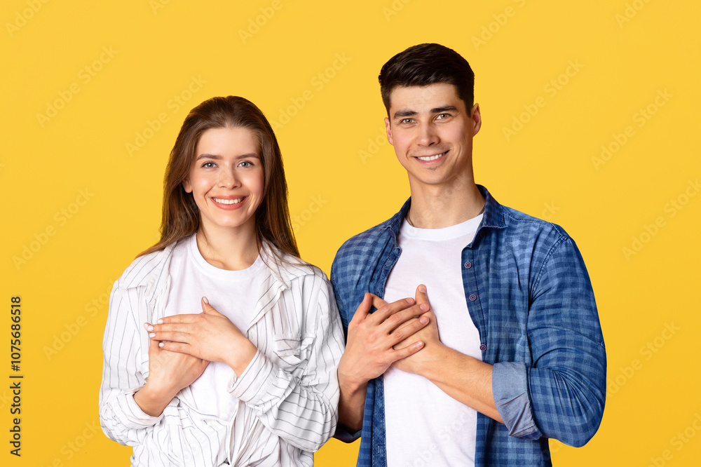 Grateful gesture concept. Pretty smiling young man and woman in casual ...