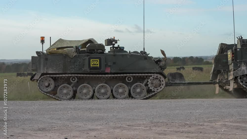 a British army Warrior FV512 MRV towing a Bulldog FV432 a convoy of ...