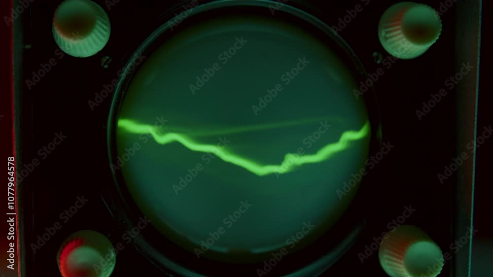 Green waveform line moving with subtle fluctuations on screen of retro ...