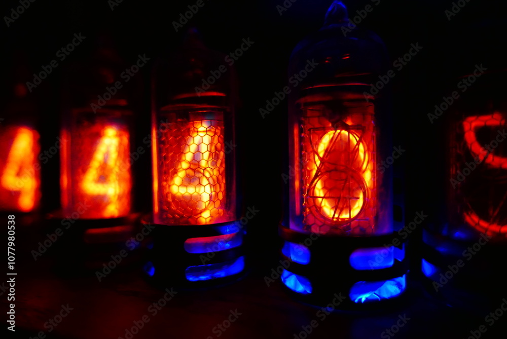 Retro Nixie lamp indicator clock on dark background. The Nixie tube ...