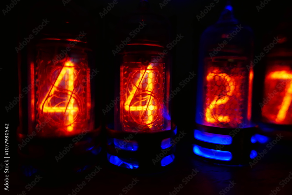 Retro Nixie lamp indicator clock on dark background. The Nixie tube ...