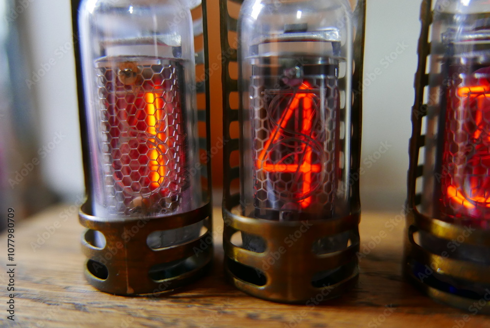 Retro Nixie lamp indicator clock on dark background. The Nixie tube ...