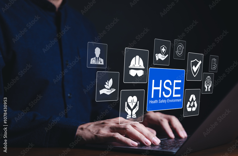 HSE - Health, Safety, and Environment. Businessman using laptop with ...