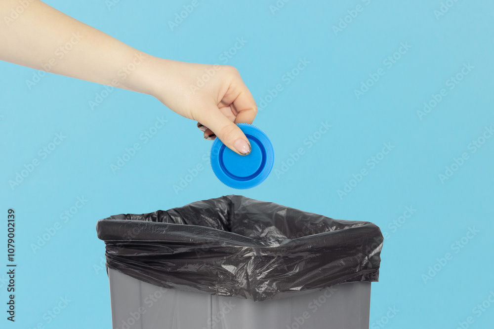 throw a cap from a plastic bottle into the trash bin, hold a cap from a ...