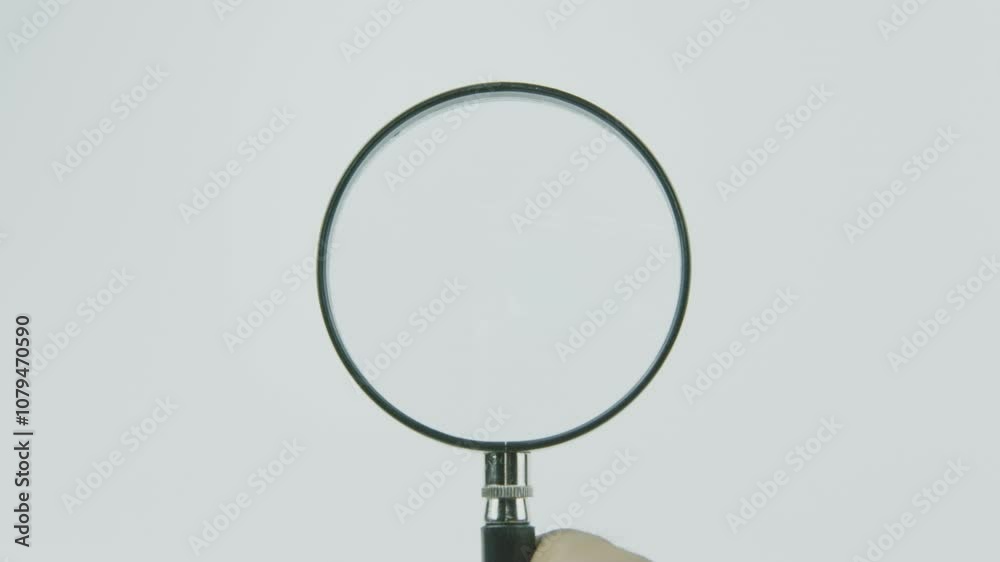 Close Up Hand Holding Big Magnifying Glass and Scanning From Right to ...