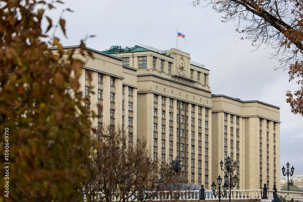 Parliament building with Russian flag in Moscow. The State Duma facade ...