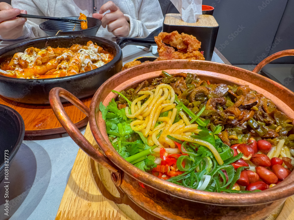 Korean cheese toppoki and Chinese oil dry noodles served with deep ...