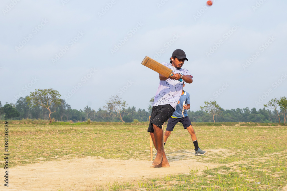 Rural boy playing cricket in village located in West bengal, India ...