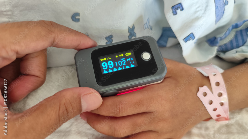 pulse oximeter on the finger of a child patient. a device to monitor ...