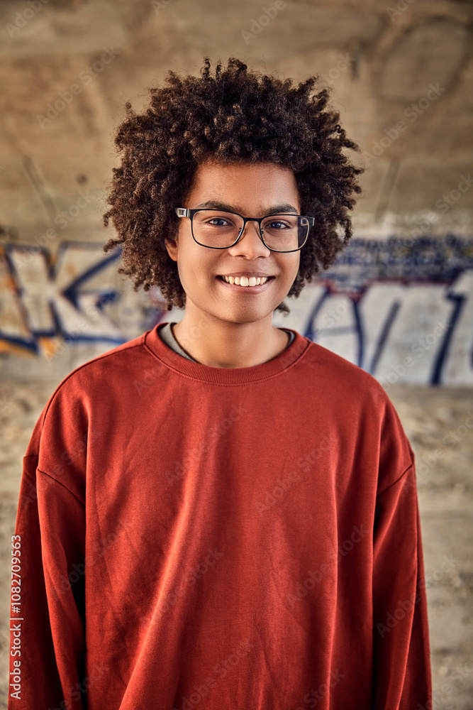 Gen Z boy outside under a bridge smiling at the camera. Munich, Germany ...