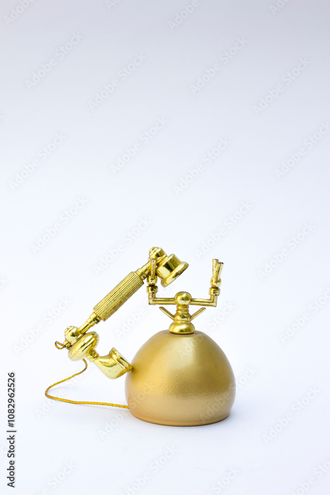 Vintage Golden Telephone with Rotary Dial: This elegant image showcases ...