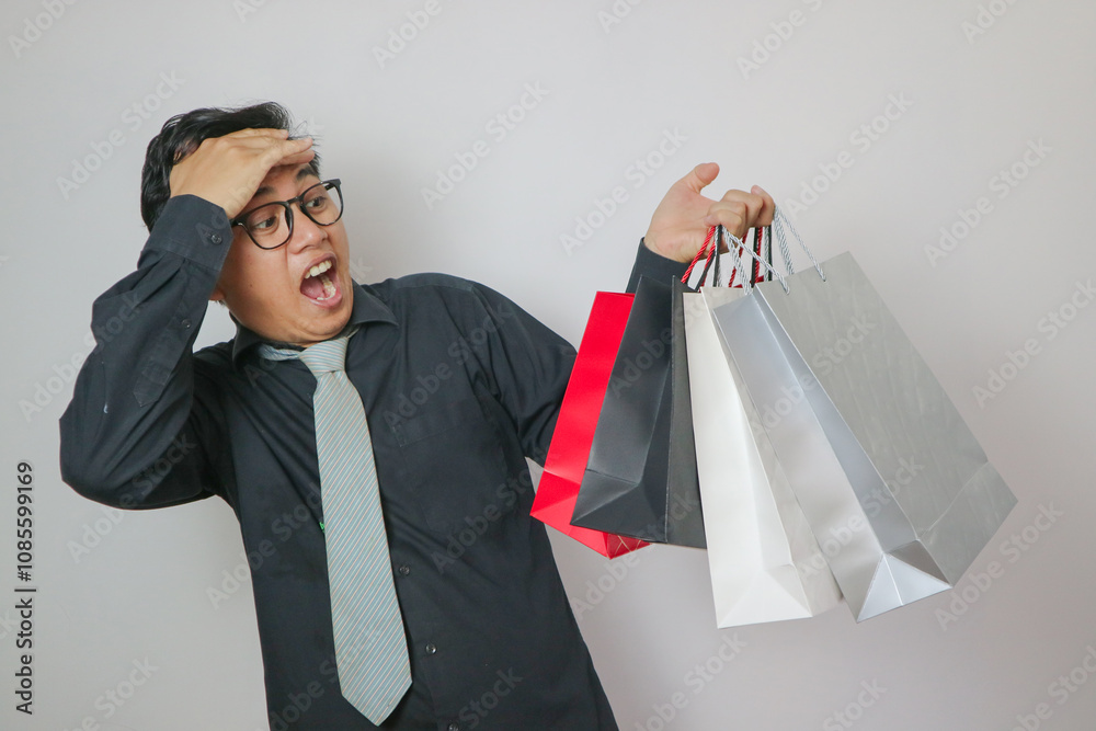 Young Asian man surprised, impressed and happy wearing office clothes ...