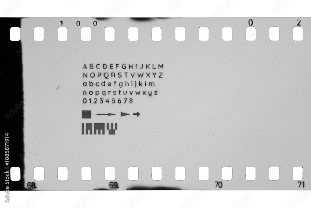 Plakát 35mm film with perforations and different letters, digits ...