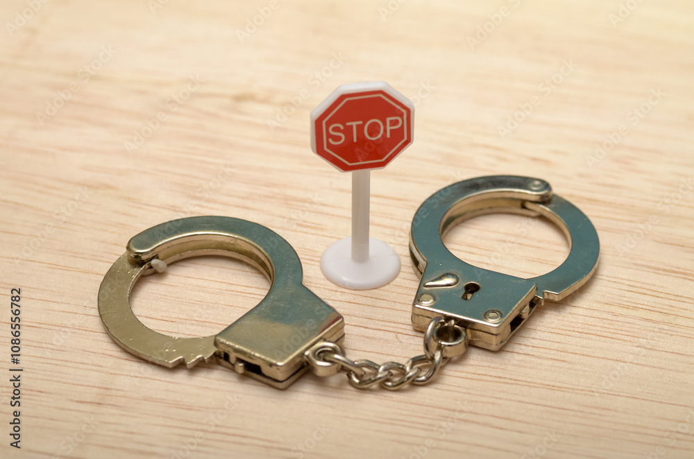 Poster The juxtaposition of the "STOP" sign and the handcuffs creates a ...