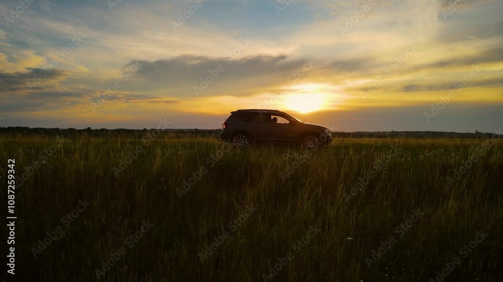 Rugged SUV crossing green expanses of farmland. Off road 4x4 car under ...
