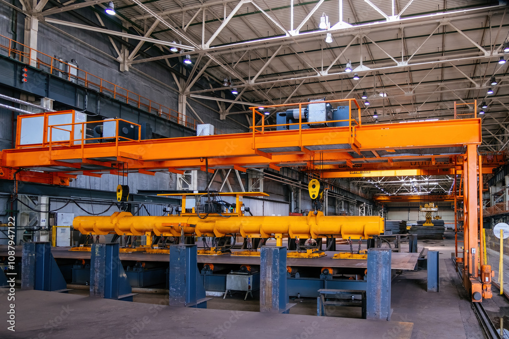 Poster Overhead crane with magnetic grippers lifting steel sheets ...