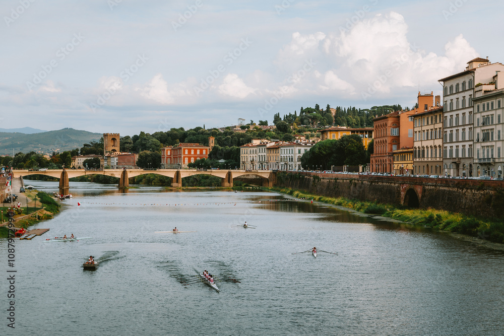 Several rowing teams are training on the arno river in florence with ...