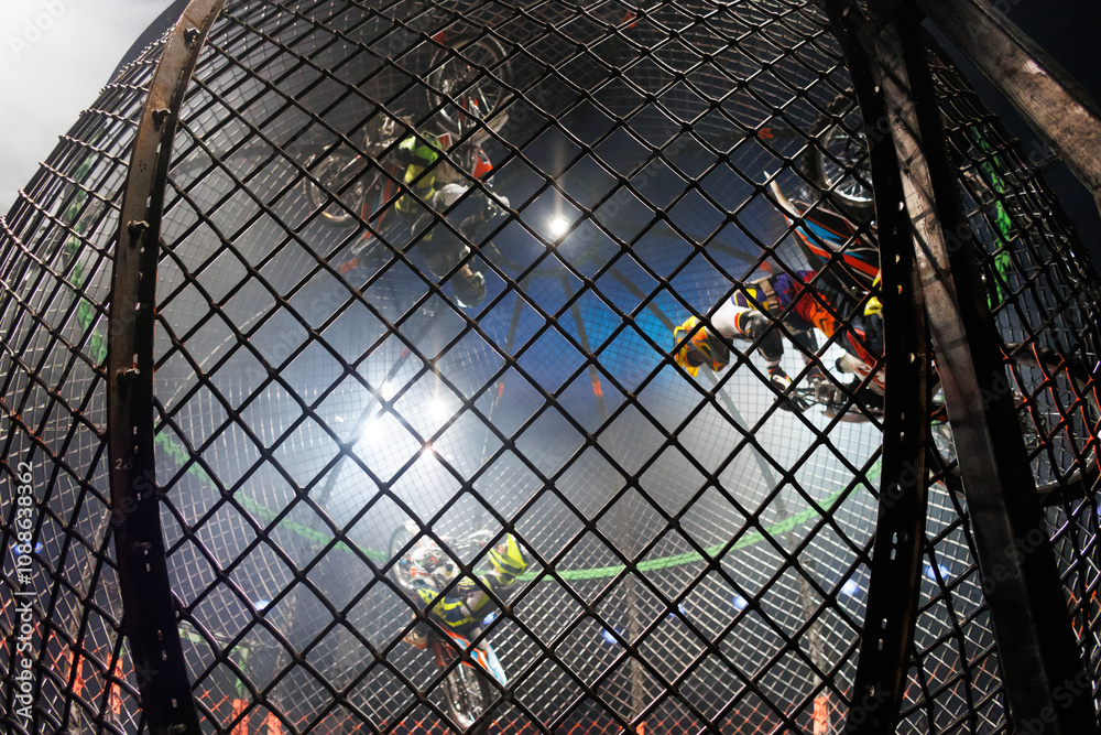 Dangerous show involving motorcyclists in circus. Stuntmen ride ...