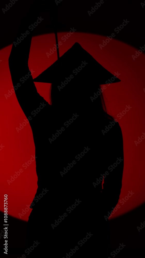 A woman in a mask and Japanese traditional headdress sugegasa poses ...