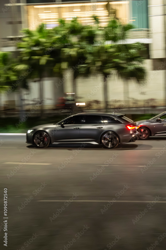 Grey Audi RS6 cruising city street at night, Luxury Wagon in motion ...