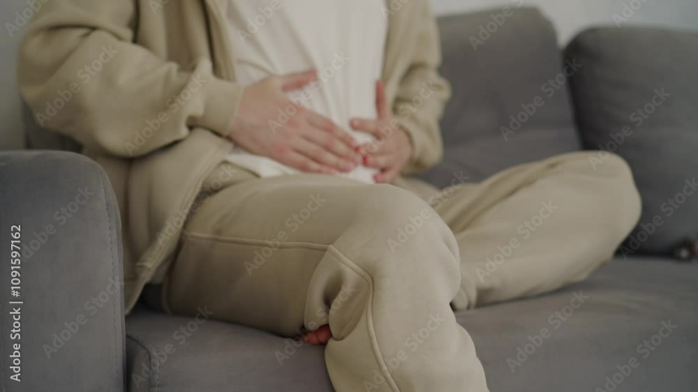 Abdominal pain from overeating. A man holds his stomach with his hands ...