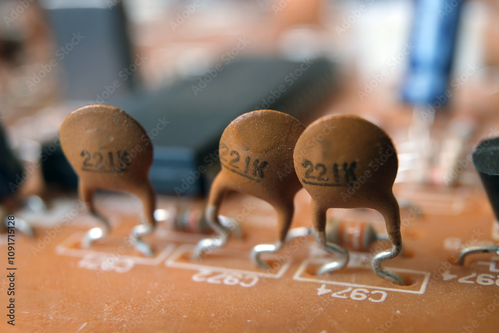 Ceramic disc type capacitors on the electronic circuit board. Focused ...