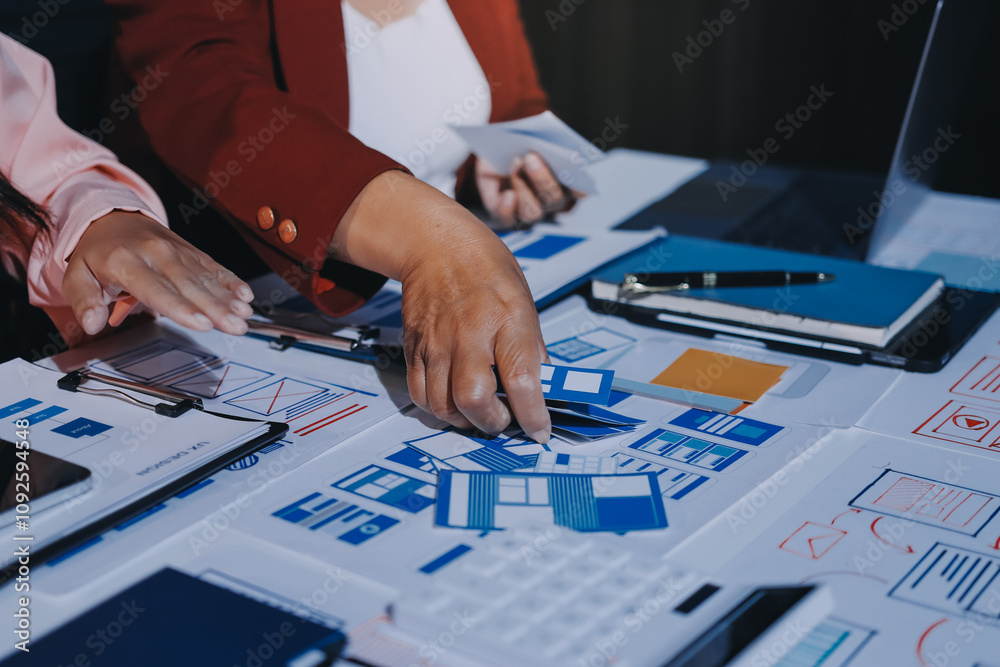 Young Asian business creative team work together, mobile application software design project ...