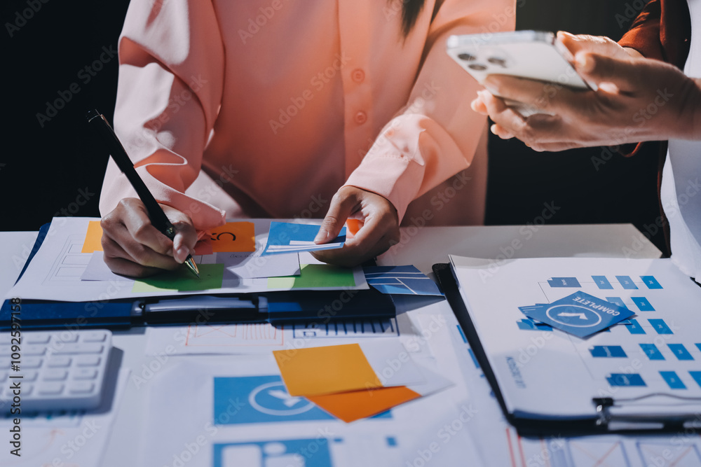 Young Asian business creative team work together, mobile application software design project ...