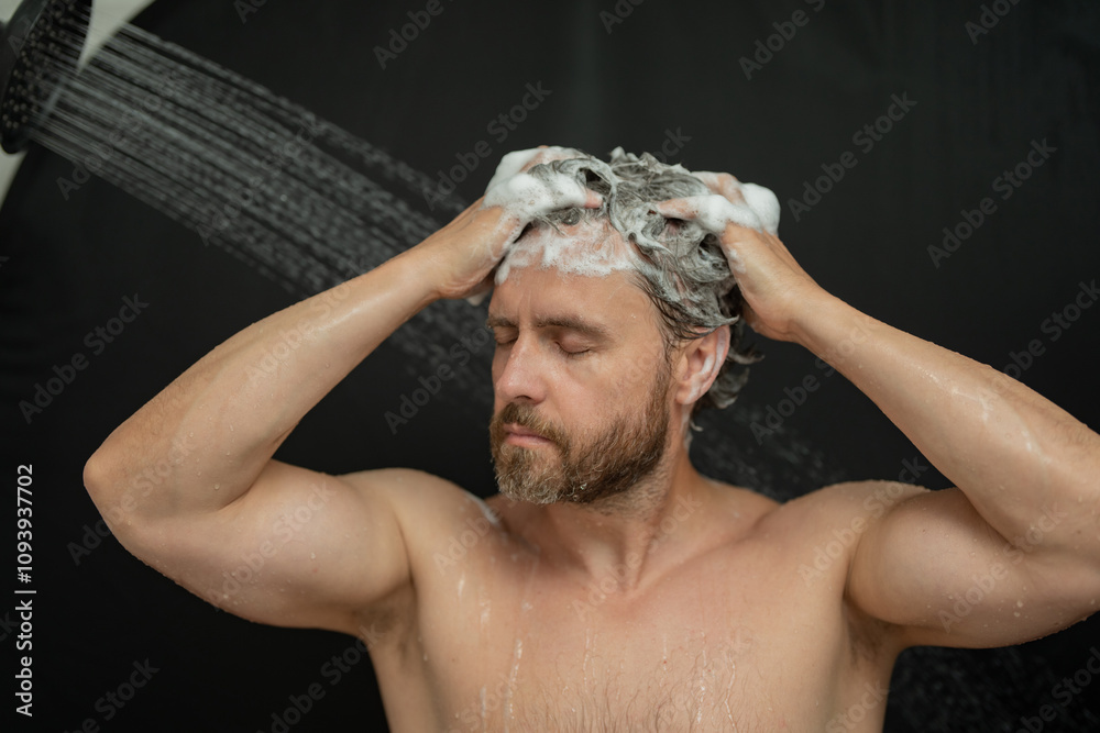 Man washing hair in bath. Guy bathing shower head in bathtub. Face in ...