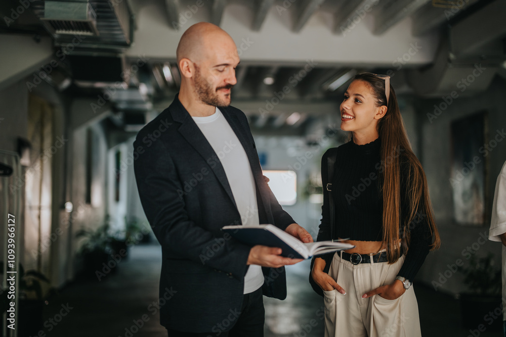 Two students engage in a pleasant conversation with a professor in a ...