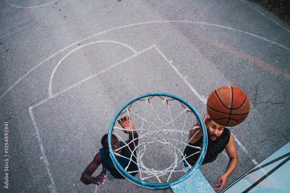 An aerial perspective showing basketball players vying for possession ...