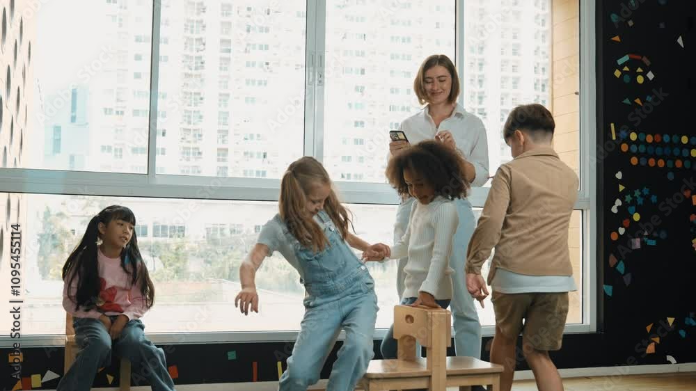 Diverse children playing musical chairs games while young smart ...