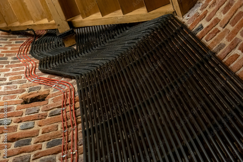 Thick shielded electrical power or data cables on s historic brick wall ...
