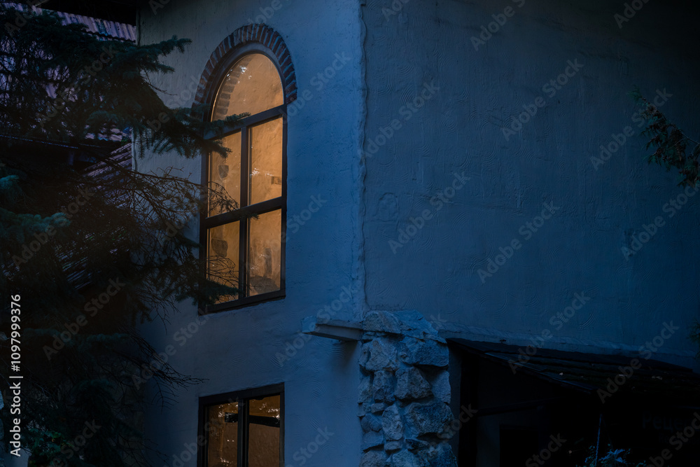 warm yellow light from window arch shape architecture building external ...