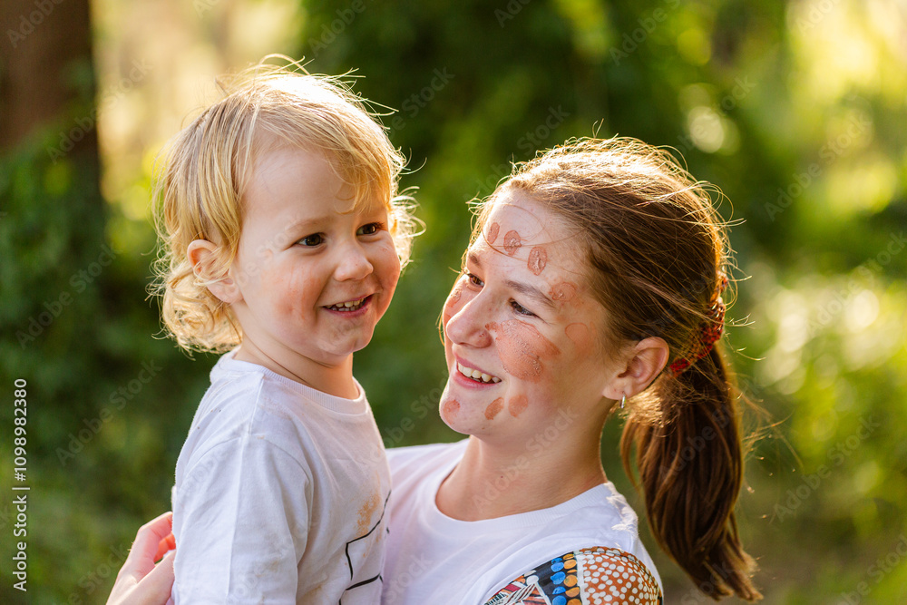Happy little First Nations Australian boy smiling with big sister Stock ...