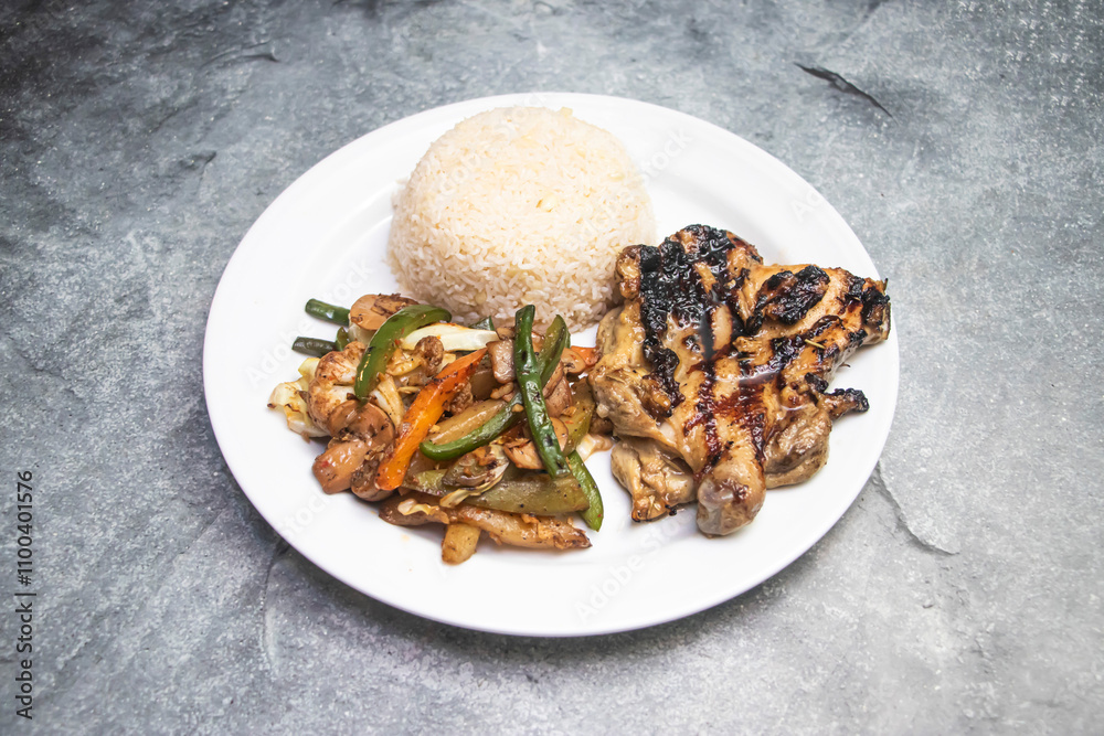 grilled chicken with garlic rice saute vegetables served in plate ...