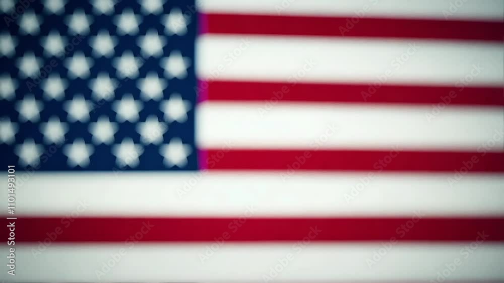 A blurred American flag becomes clear elegantly waves in the wind ...