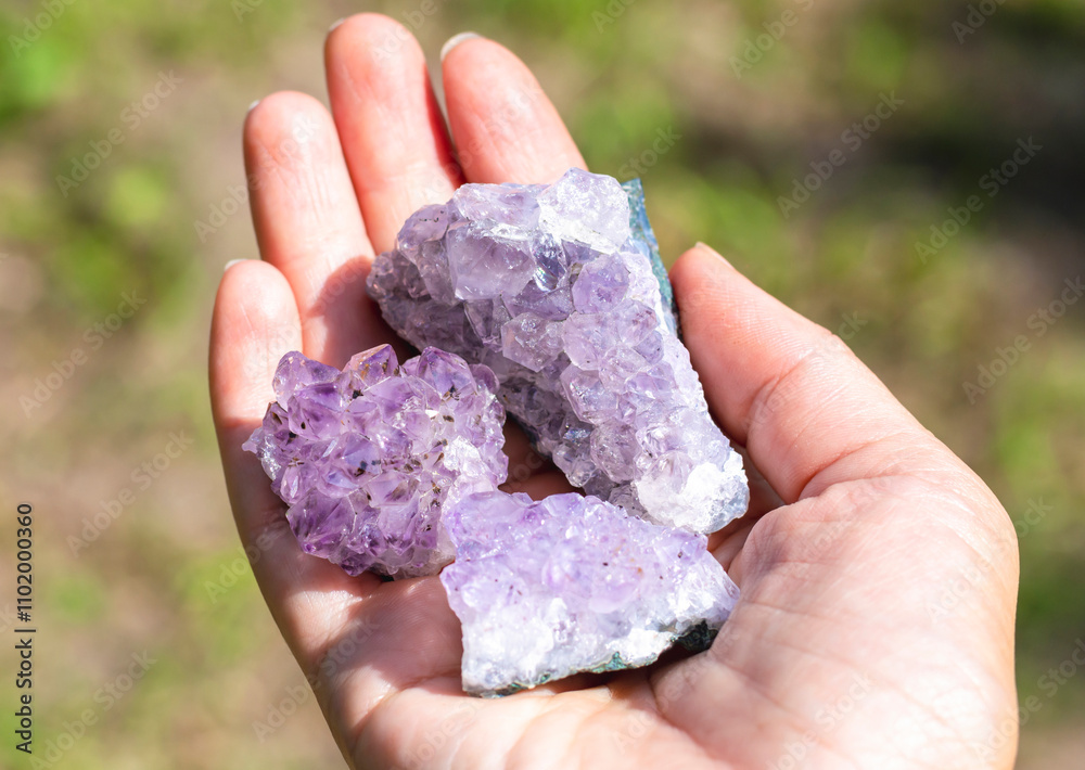 Natural mineral amethyst in hand. Semi-precious multi-colored stones ...