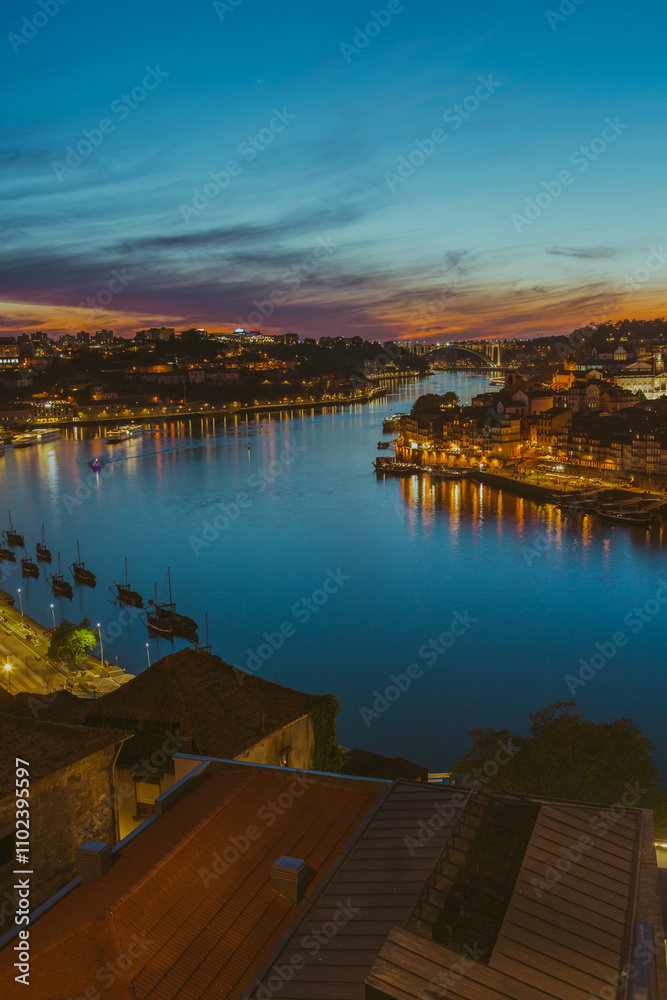 Blue sky is reflected on the river Douro between Porto and Gaia with ...
