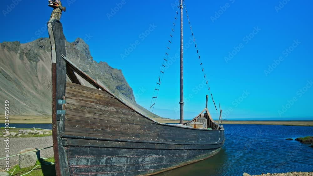 Viking village with wooden houses, grass roofs and a long ship Viking ...