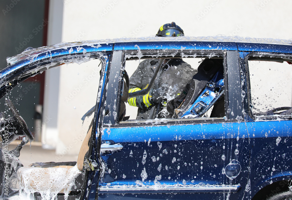 Firefighter behind a destroyed blue car after an accident while he ...