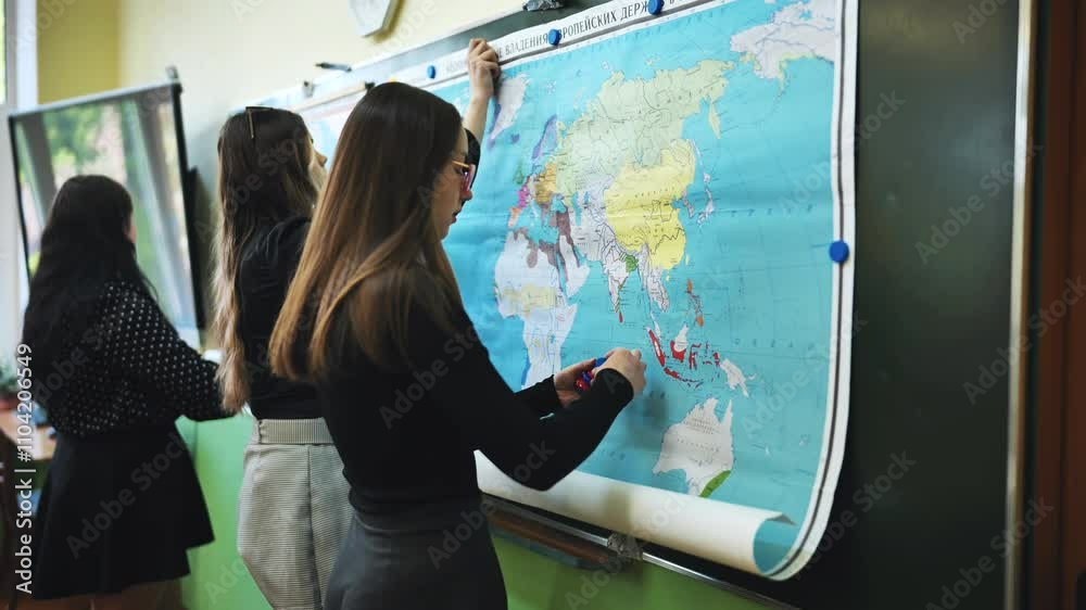 High school students are learning geography, positioning markers on a ...