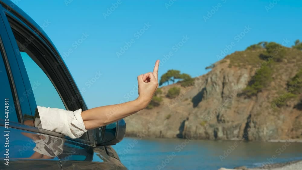 Woman in car showing middle finger gesture. Woman sticking her arm out ...