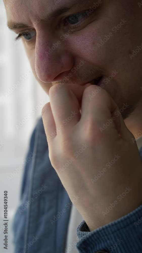 A man bites his fingernails. A bad habit for a human. Fingernails in ...