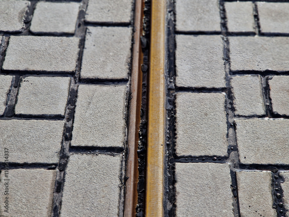new tram tracks. in the city on the promenade. paving made of bricks ...