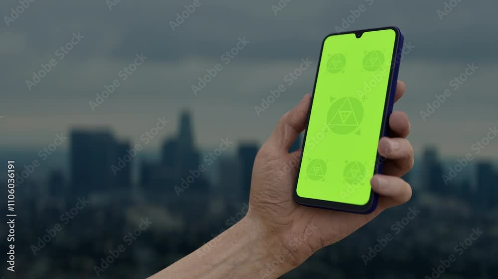 GREEN SCREEN CHROMA KEY A hand holding a smartphone with a green screen ...