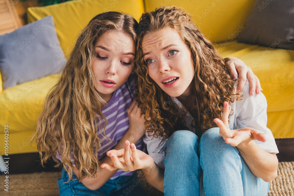 Two young girls sit together indoors, engaging in heartfelt ...